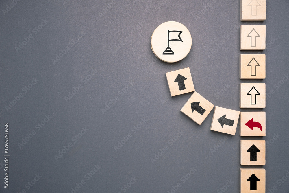 Wooden blocks with arrows and goal icon showing a change of direction ...