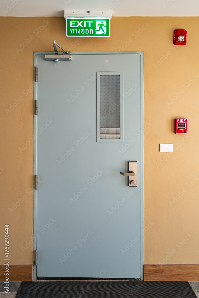 Emergency Exit Door with Green Sign, Fire Alarm, and Safety Equipment ...