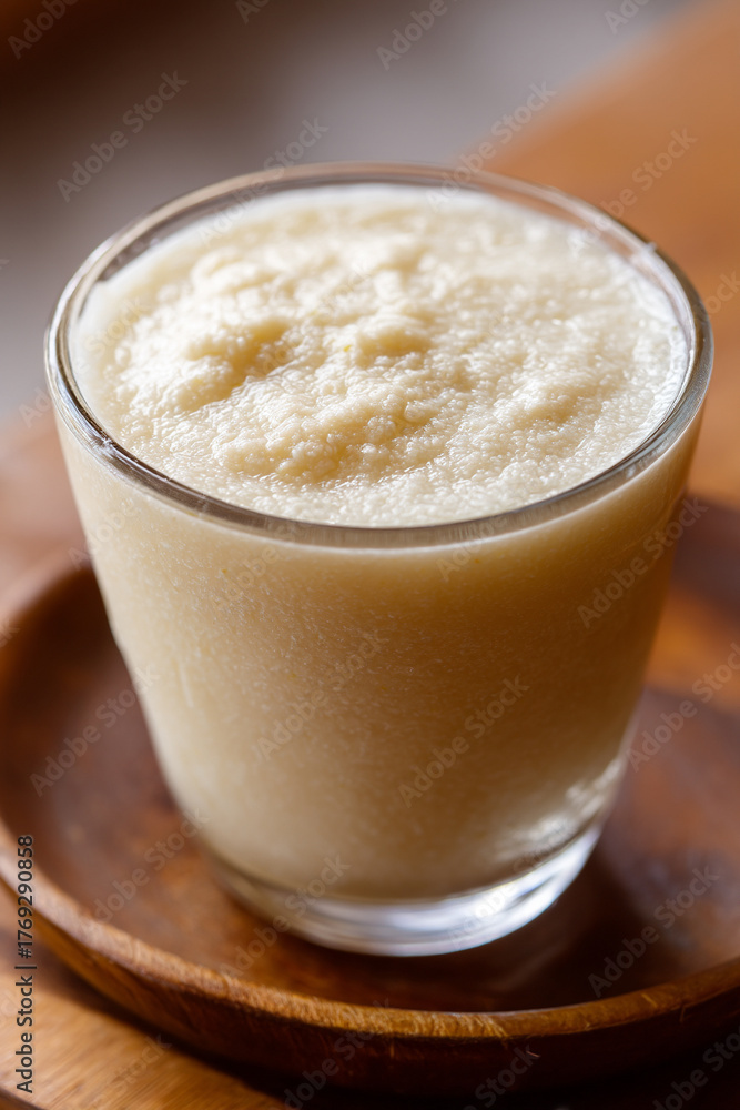 A close-up of Mahewu (fermented maize drink), thick and creamy, a ...