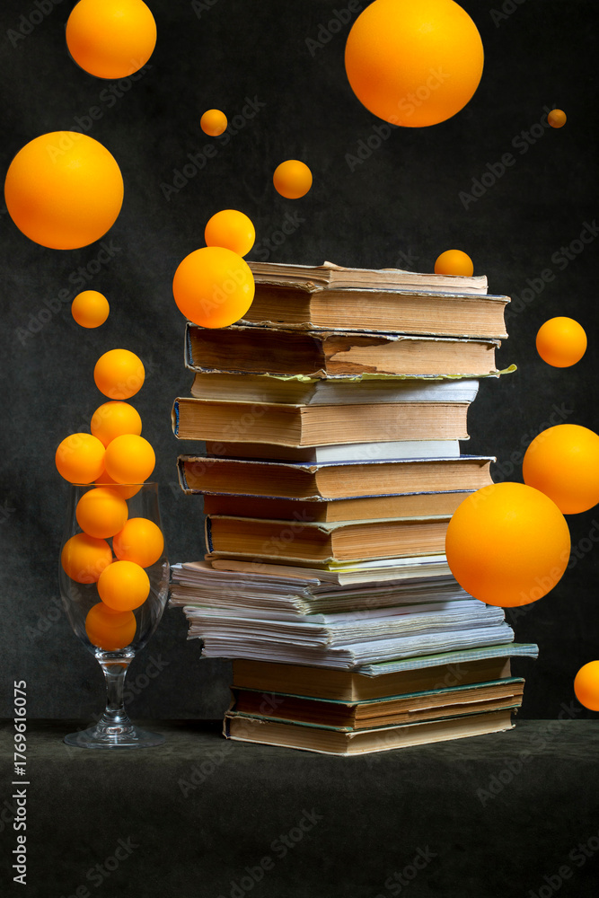 Still life with a stack of books and orange balloons Stock Photo ...