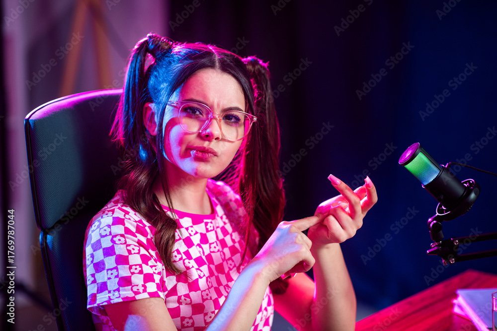 Popular female vlogger in a neon-lit room hosting a podcast with a ...