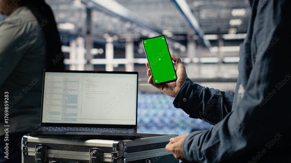 Server room software developer using mockup phone while waiting for ...
