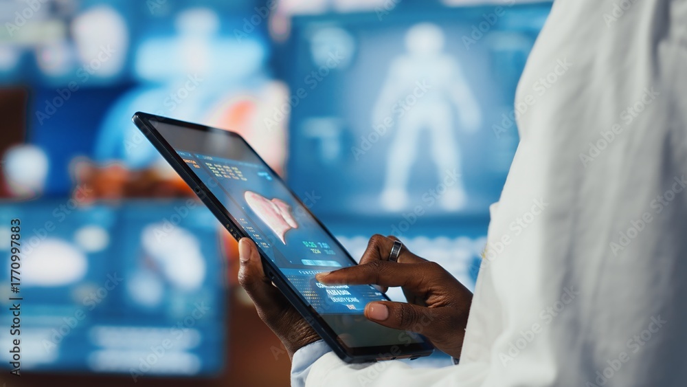 Close up of researcher analyzing human anatomy using tablet app in ...