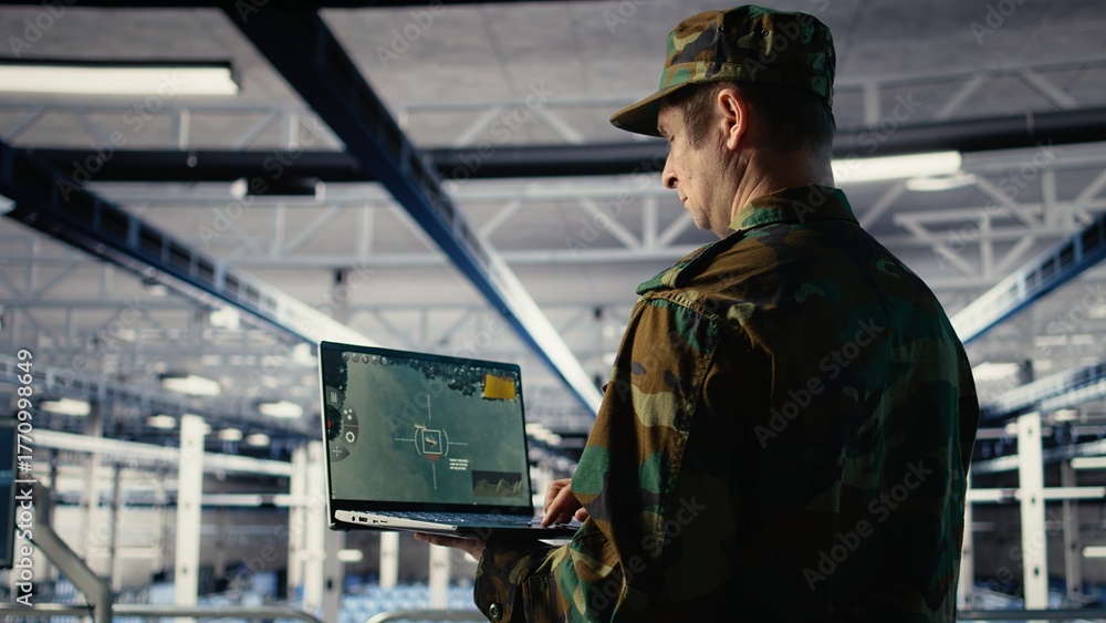Military technician in data center tracking satellite coordinates using ...