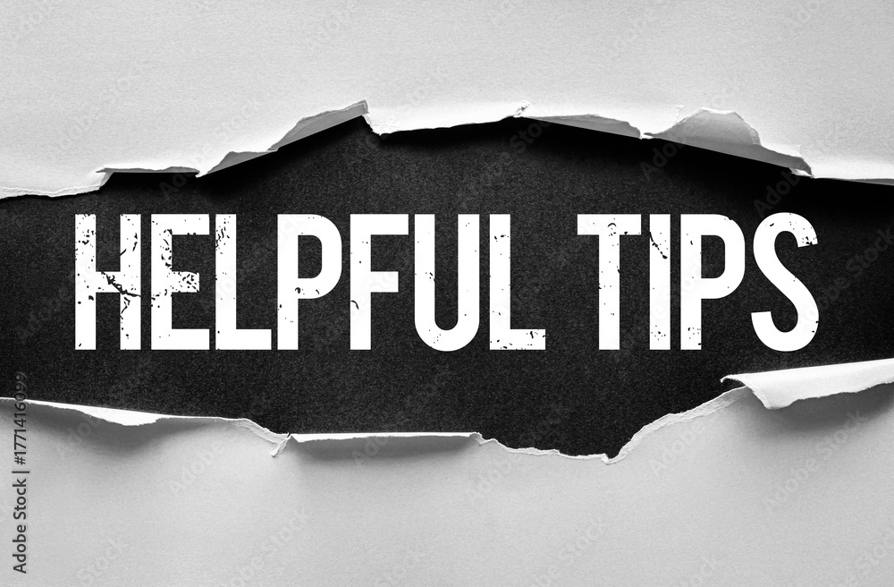 Torn paper reveals the bold, distressed words HELPFUL TIPS on a ...