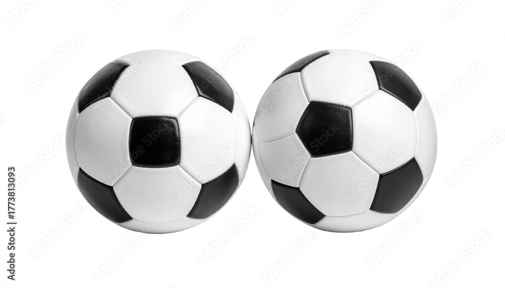 Two classic black and white soccer balls are placed side-by-side on a ...