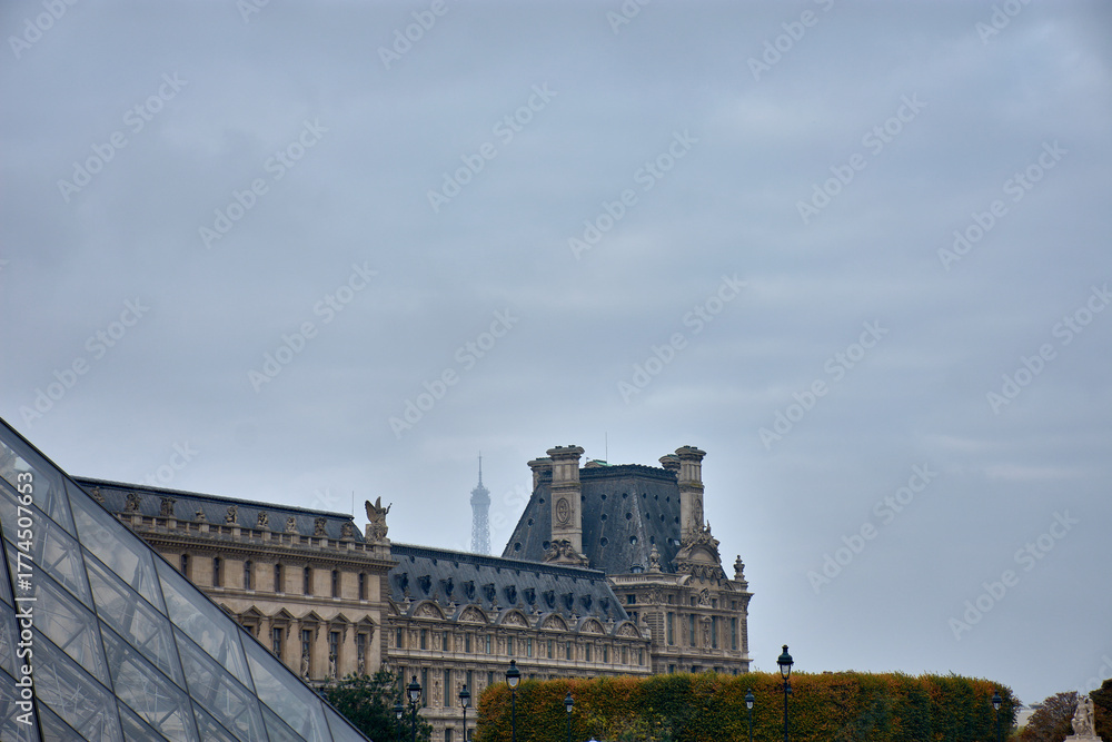 Classical facade of the Louvre Museum in Paris with cloudy skies and ...