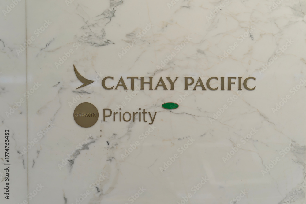 Priority sign and Cathay Pacific logo at Hong Kong International ...
