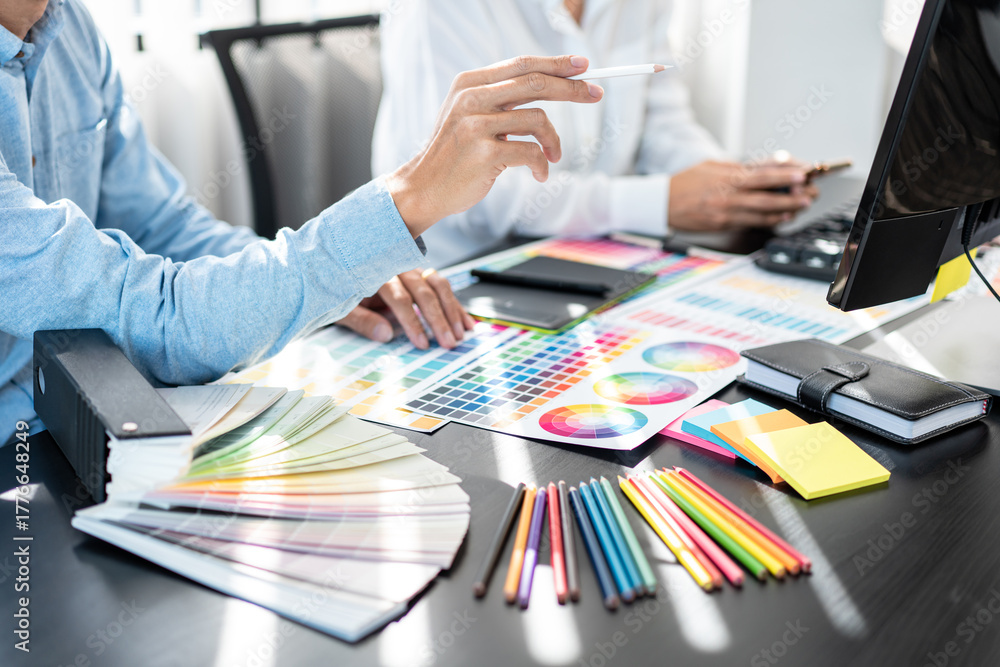Team of creative graphic designer working on color swatch samples chart ...