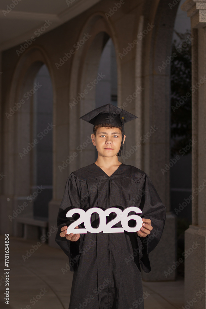 Student in Graduation Cap and Gown Proudly Holding 2026 Sign at a ...