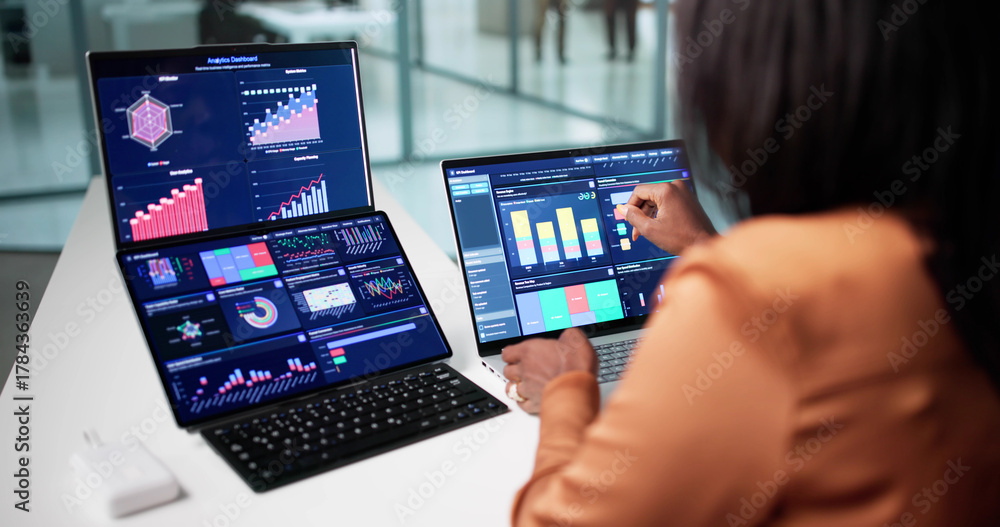 Focused African American Woman Analyzing KPI Data Stock Photo | Adobe Stock
