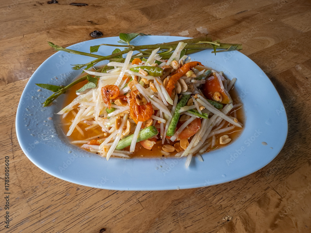 Authentic Som Tum, a spicy Thai papaya salad, featuring crisp shredded ...