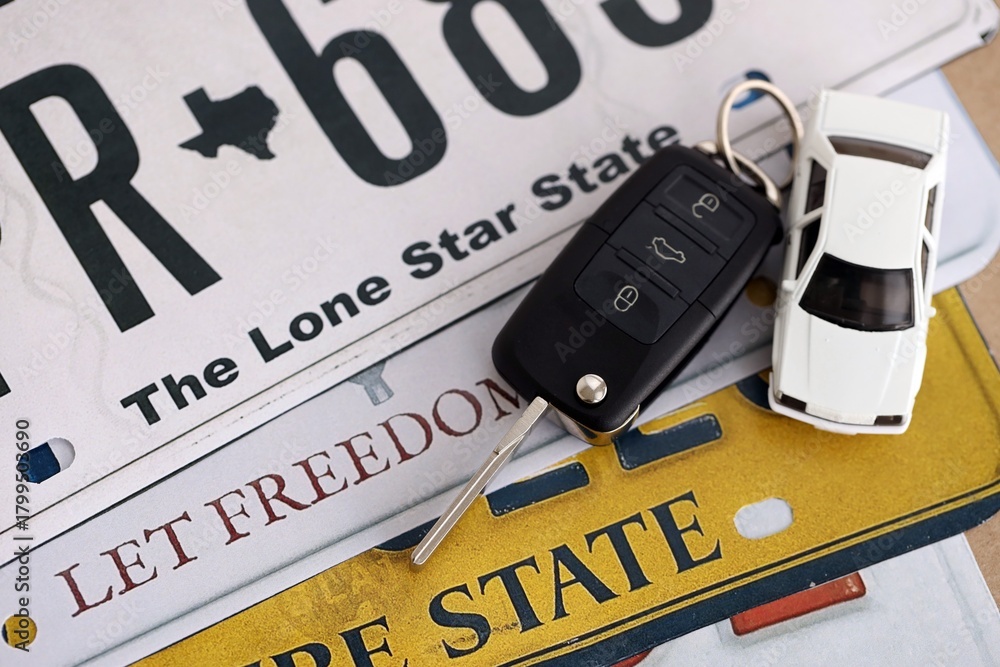 Remote control car keys on US license plates with state names close up ...