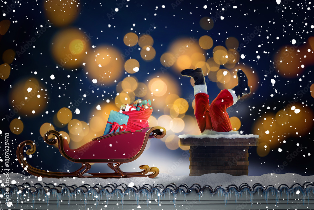 Santa Claus crawling into chimney under falling snow at night. His legs ...