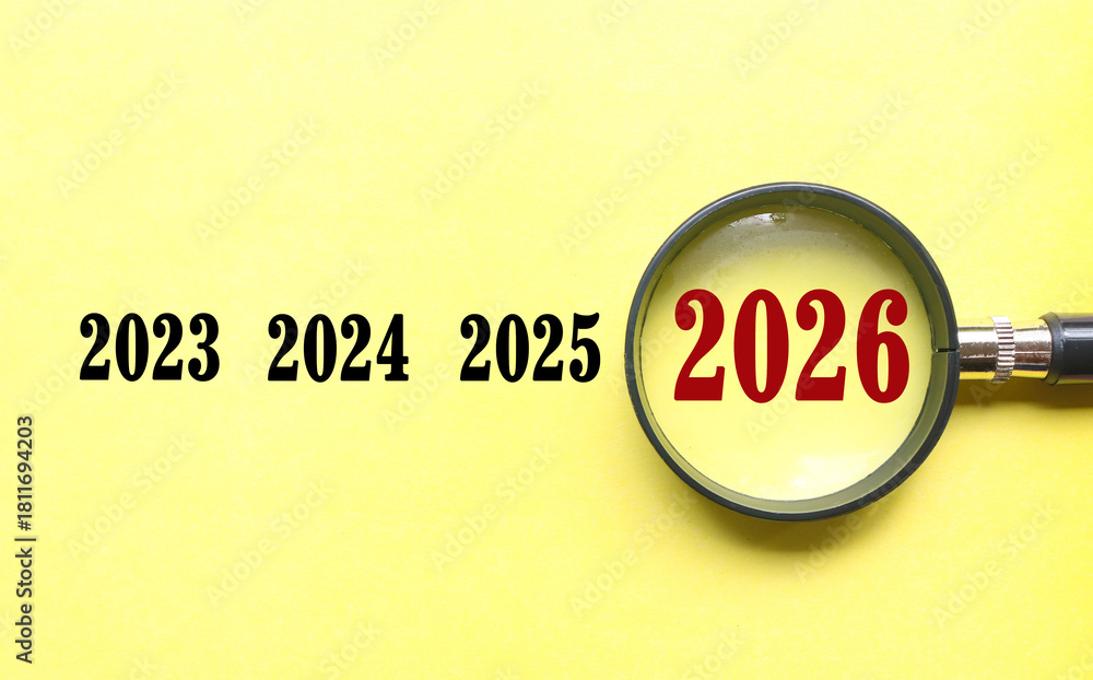 Foto de Stock New Year 2026 is enlarged using a magnifying glass on ...