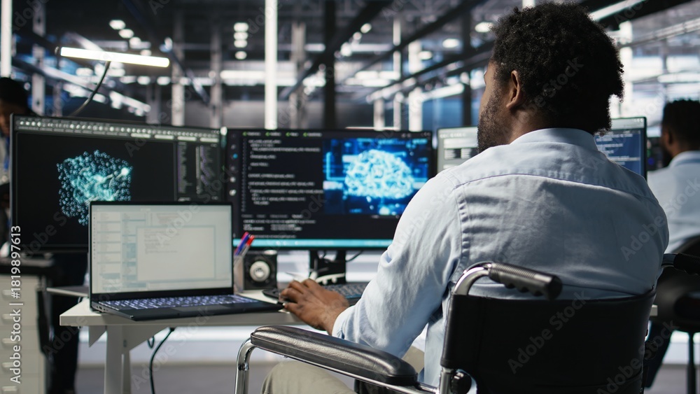 ภาพถ่าย Stock Server hub programmer with paraplegia in wheelchair uses ...