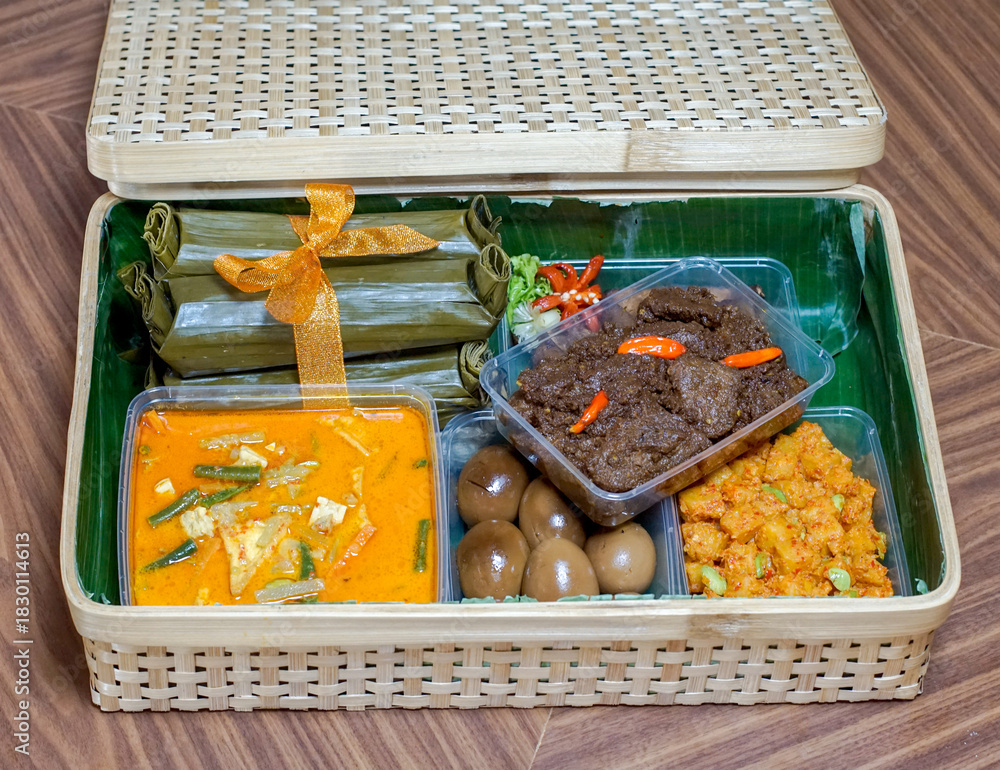 Indonesian traditional food hamper containing rendang, lontong wrapped ...