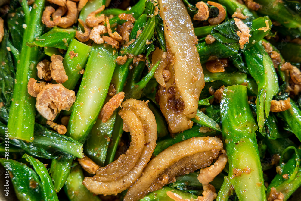 Stir-fried Chinese broccoli with crispy pork belly, seasoned with soy ...