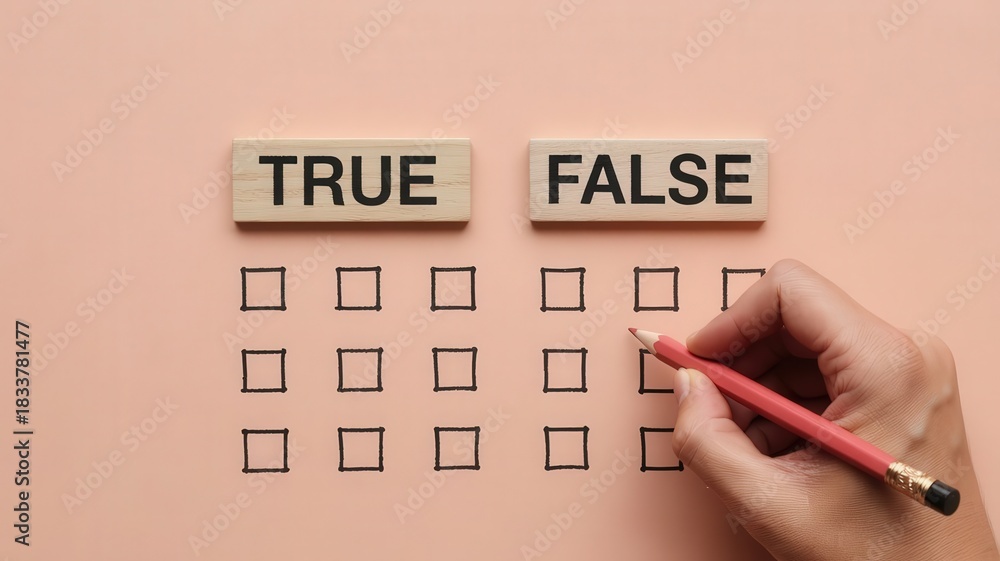 Wooden blocks displaying 'TRUE' and 'FALSE' guide a hand filling out a ...