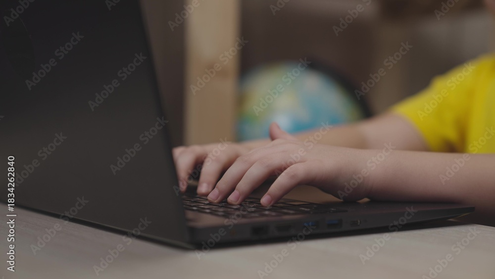 children hands typing keyboard. close-up. boy studying remotely at home ...