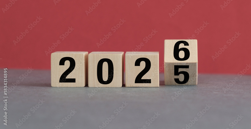 Wooden cubes with the inscriptions 2025 and 2026, the concept of the ...