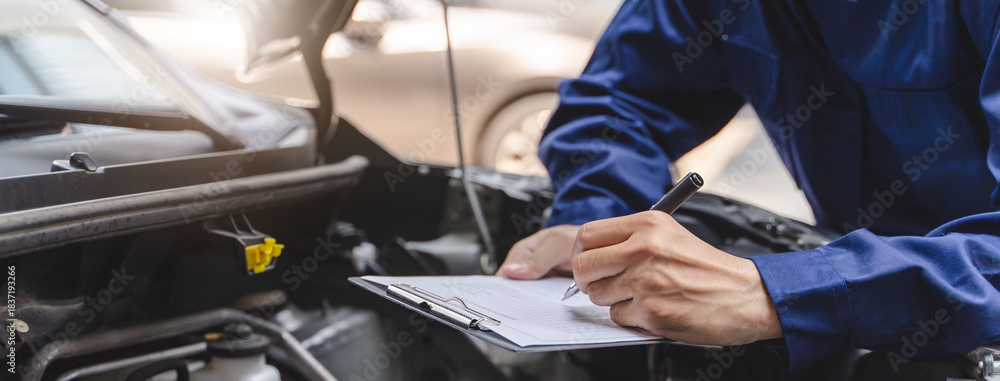 Auto check up and car service shop concept. Mechanic writing job ...