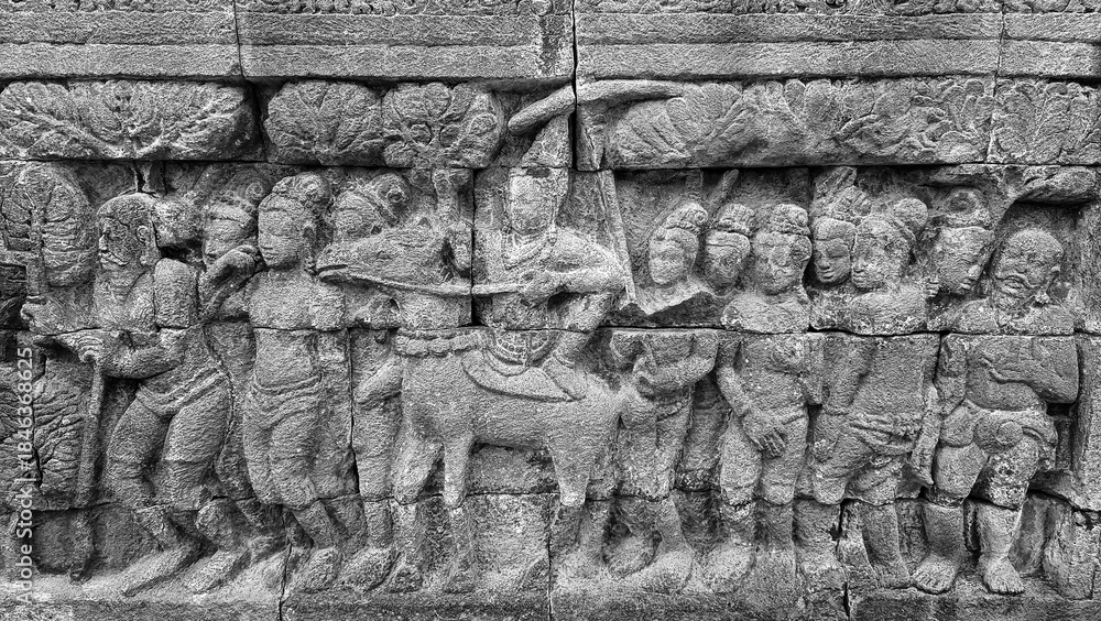 Ancient stone relief featuring human figures and an animal, carved on a ...