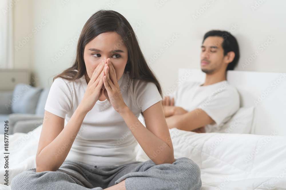 Angry, depressed, frustrated asian couple quarrel, fighting on bed in ...