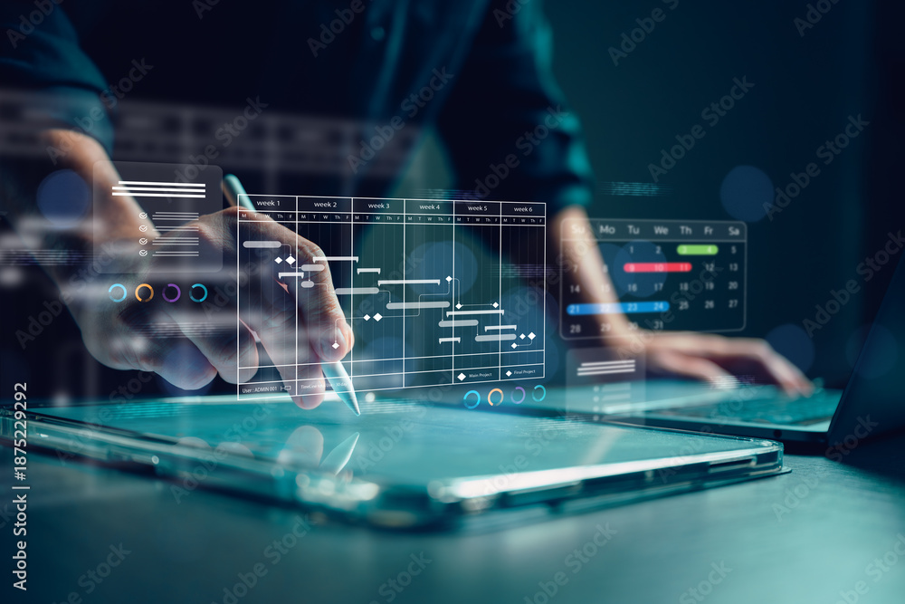 Project manager using stylus on tablet with hologram Gantt chart ...