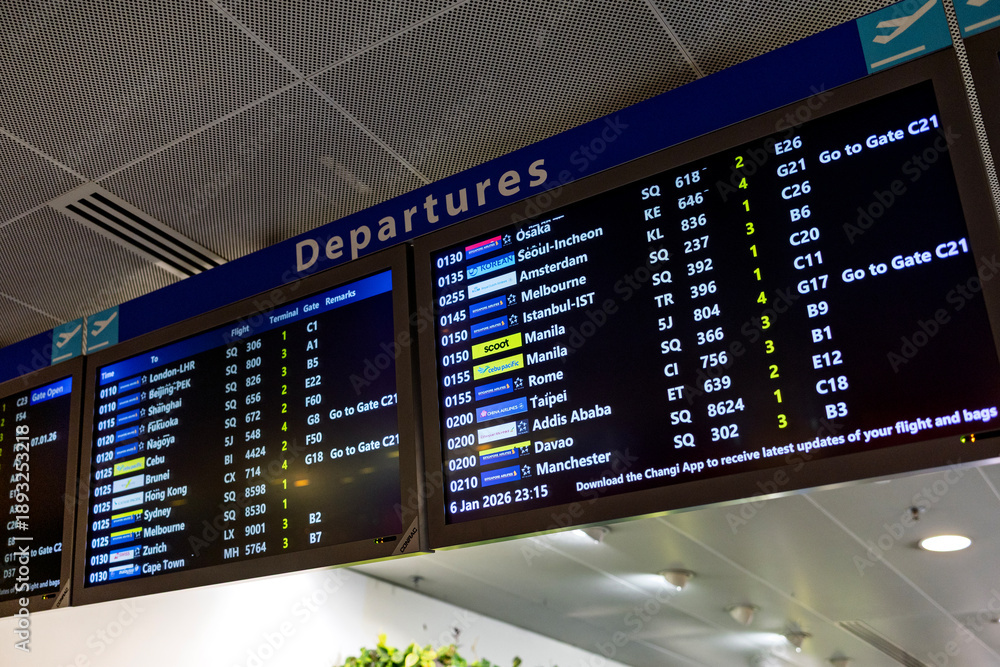 Changi, Singapore – Jan 6, 2026: A digital departure information board ...