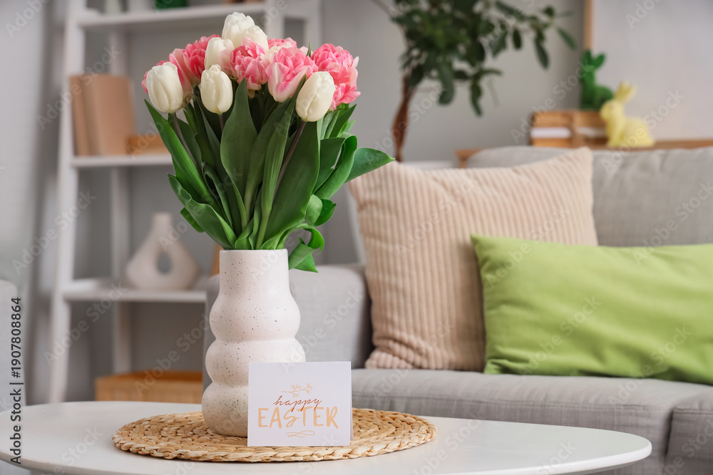Vase with tulips and card for Easter on table in living room の Stock ...