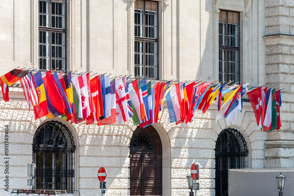 Row of national country flags at entrance of administrative building ...