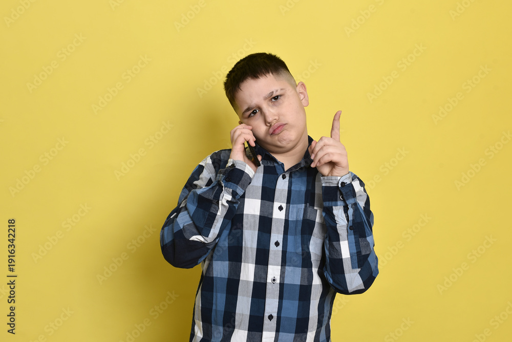 Young boy victim of phone harassment, showing the concept of ...