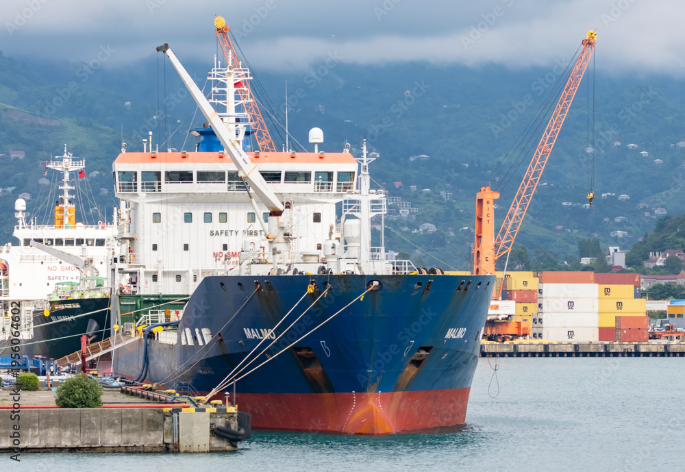 Photo Stock Cargo ship called Maluka unloading at a busy port in the ...