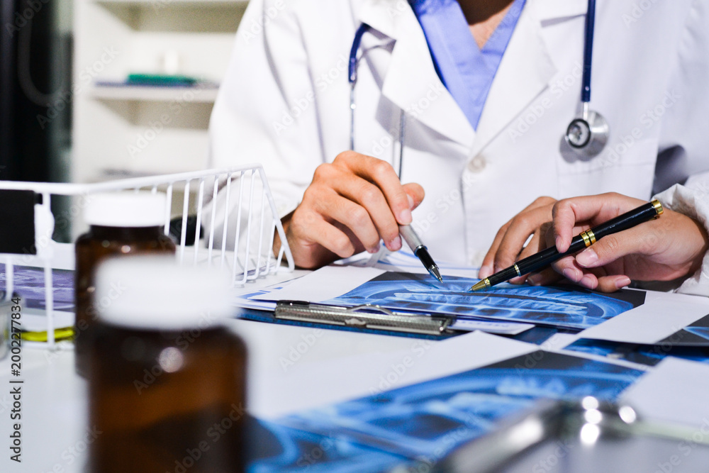 Doctor Explaining X-Ray Results to a Patient Using a Digital Device ...