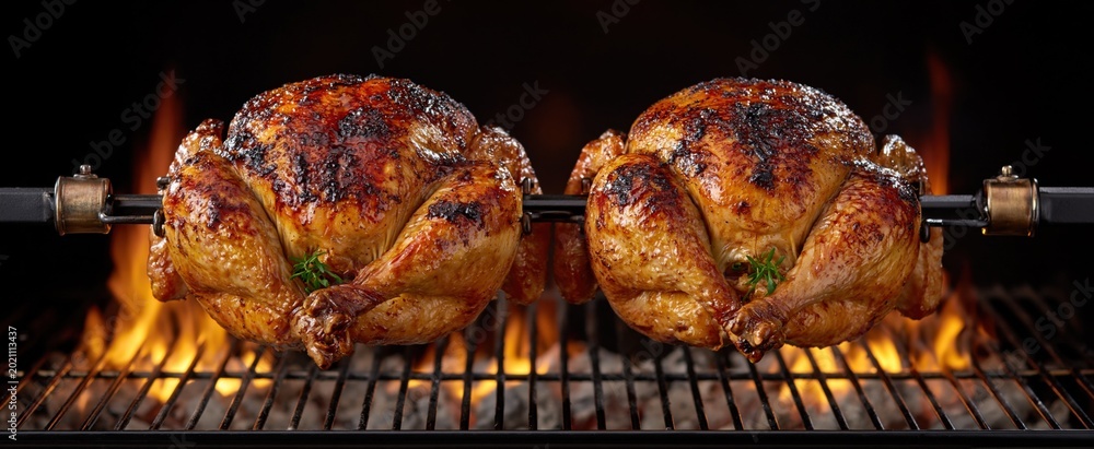 Golden Turkeys twirling like dancers on a charcoal grill cast iron ...