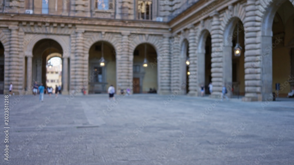 Historic stone arcade and colonnaded courtyard softly defocused in ...
