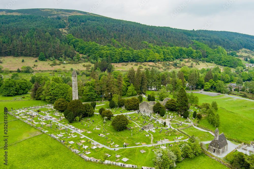 Aerial view of ancient cemetery and round tower at Glendalough Monastic ...