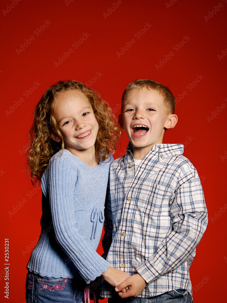 two kids on red Stock Photo | Adobe Stock