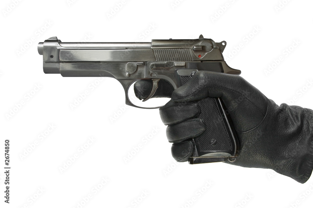 hand in glove with pistol Stock Photo | Adobe Stock