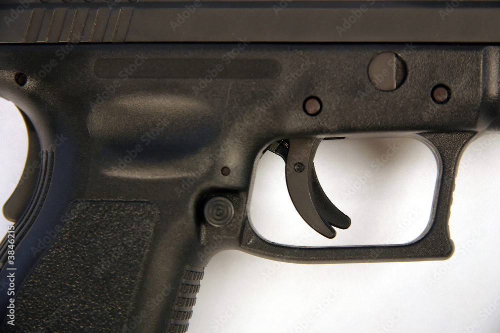 Trigger mechanism of a 9mm handgun. Stock Photo | Adobe Stock
