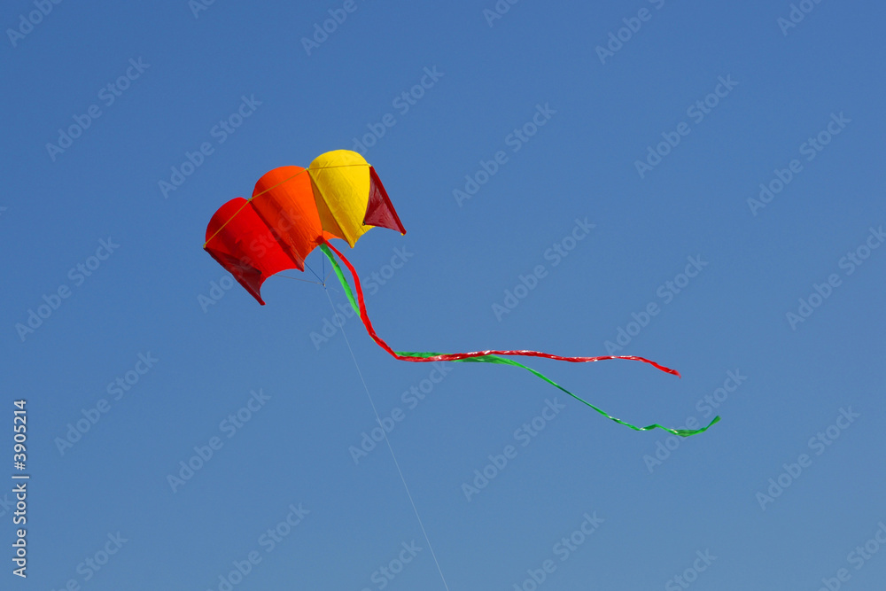 Flying kite on the blue sky background Stock Photo | Adobe Stock