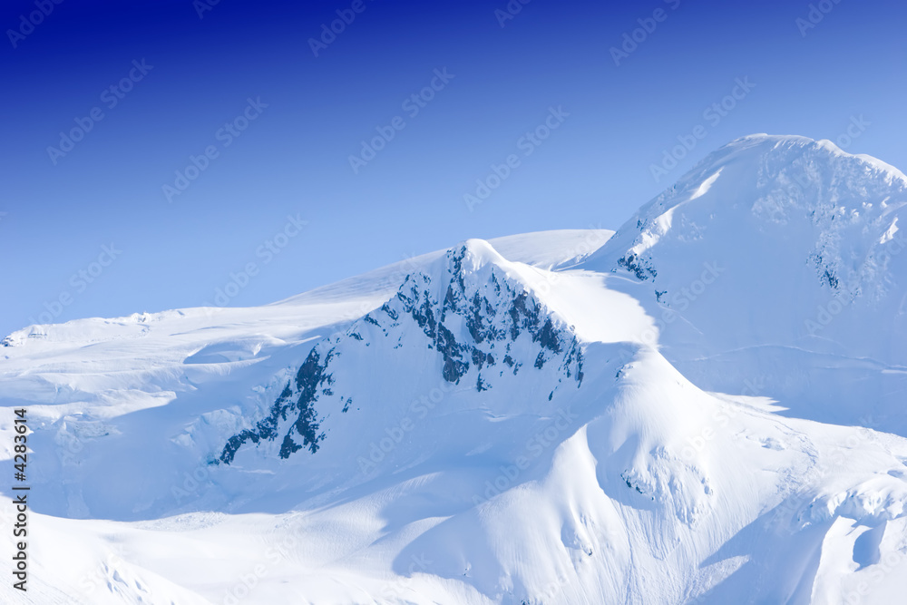 Snowy mountain peaks Stock Photo | Adobe Stock