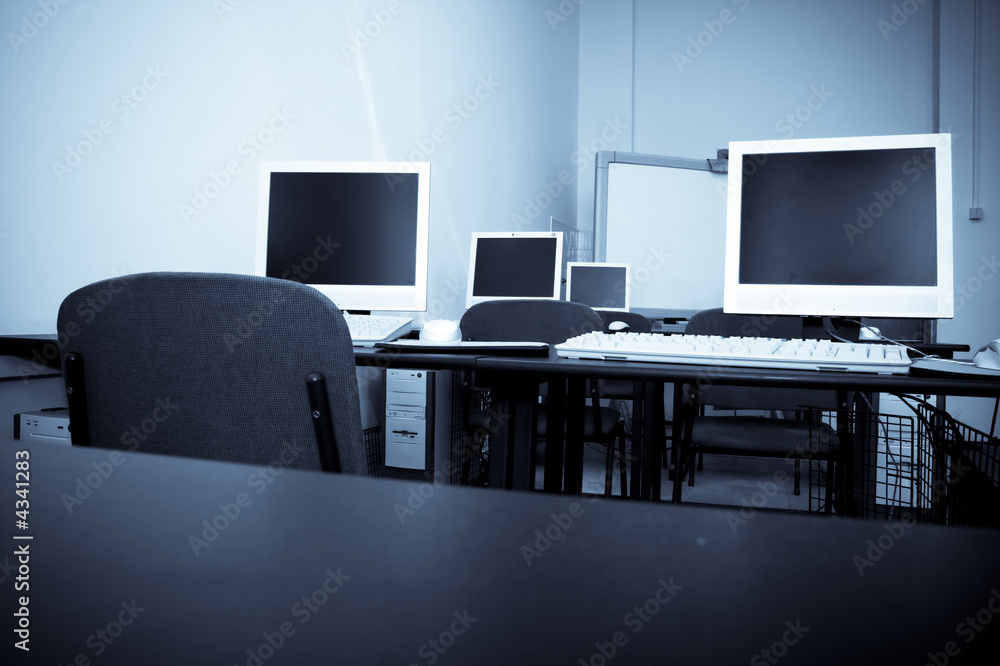 Computer classroom. Computers in row in school classroom Stock Photo ...