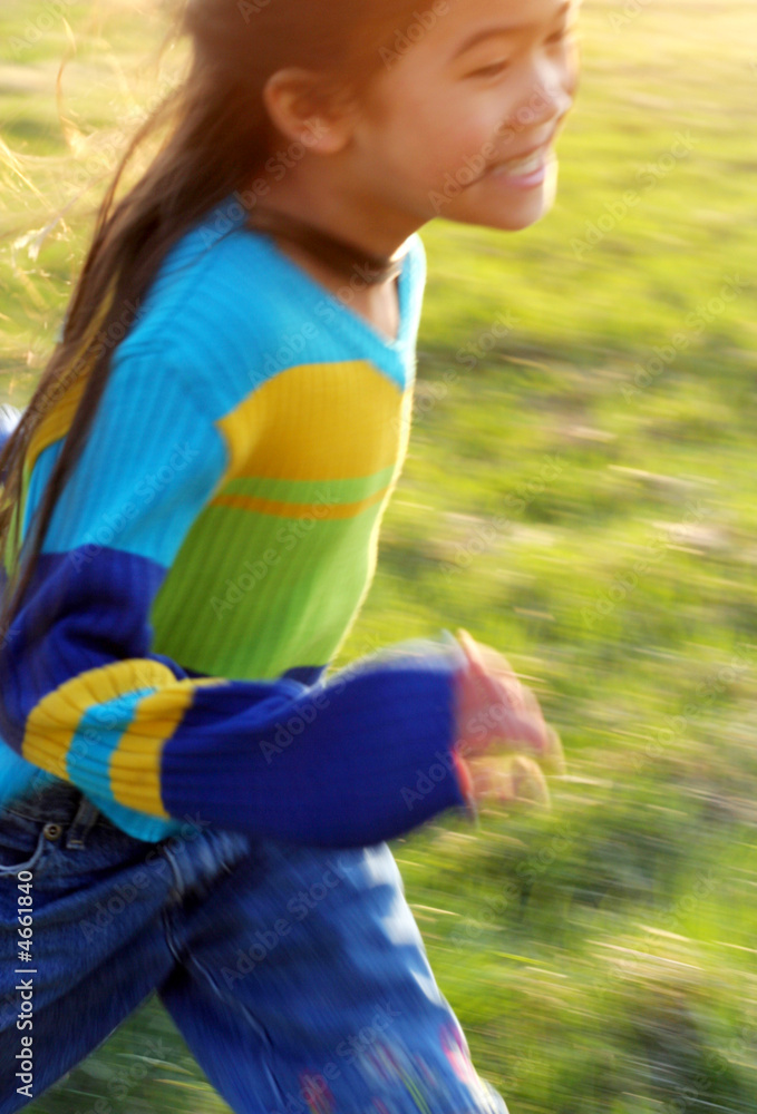 Young girl running on a grassy field, speed blur with sun flare Stock ...