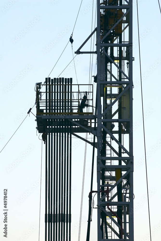 Roughneck pushes pipe from drilling rig pipe rack Stock Photo | Adobe Stock