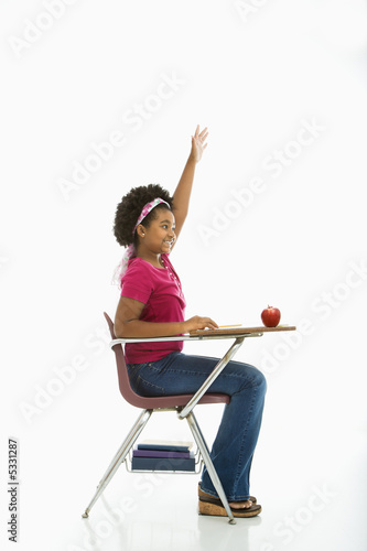 Child Sitting In A Chair At Desk