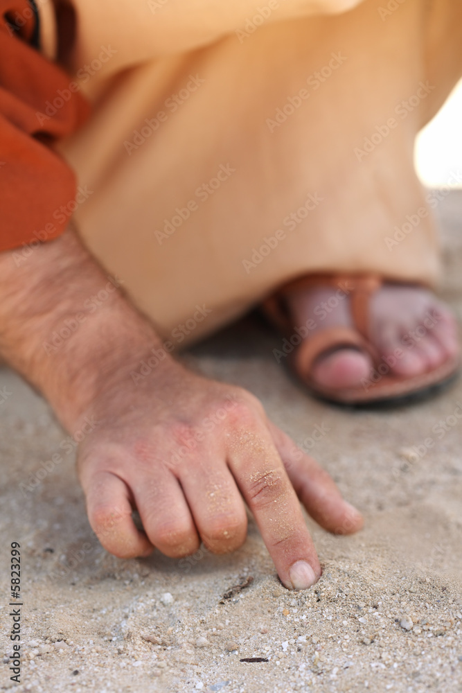 Jesus stooped down and wrote with his finger on the ground Stock Photo ...