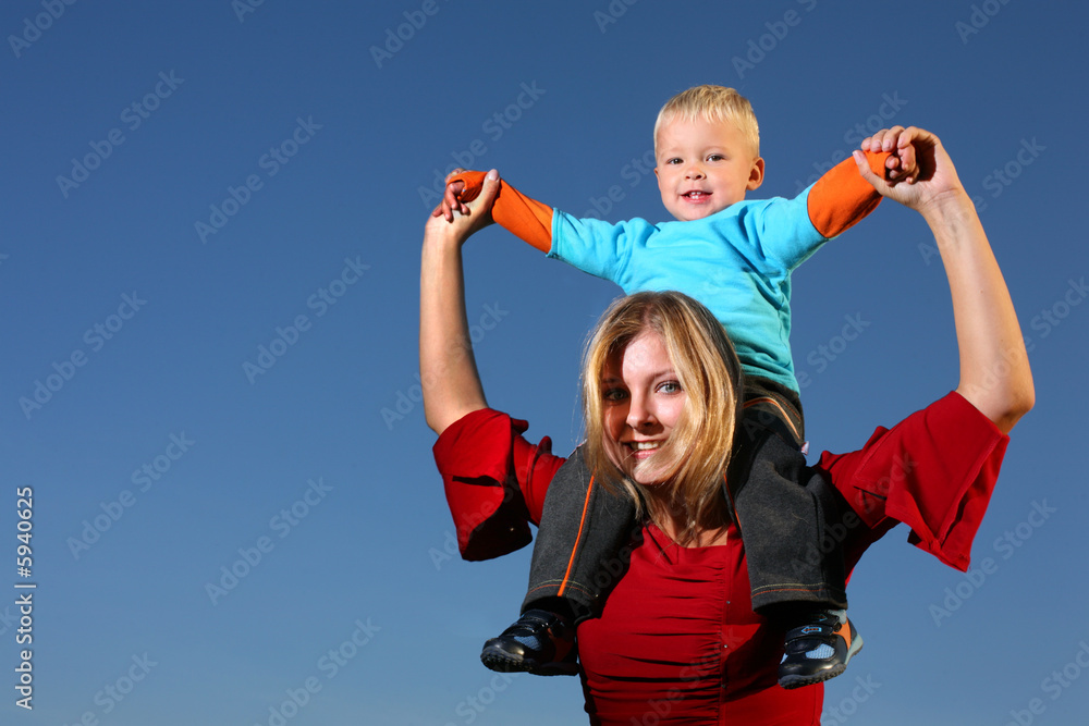 Young boy riding on his mother's shoulders outdoors Stock Photo | Adobe ...