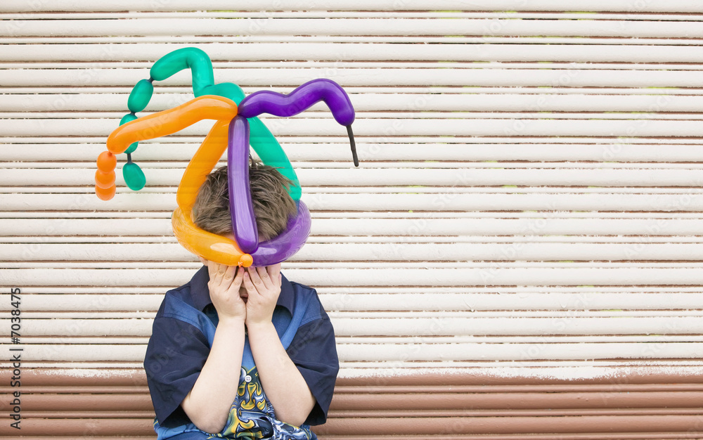 Sad Boy with a Balloon Hat Stock Photo | Adobe Stock